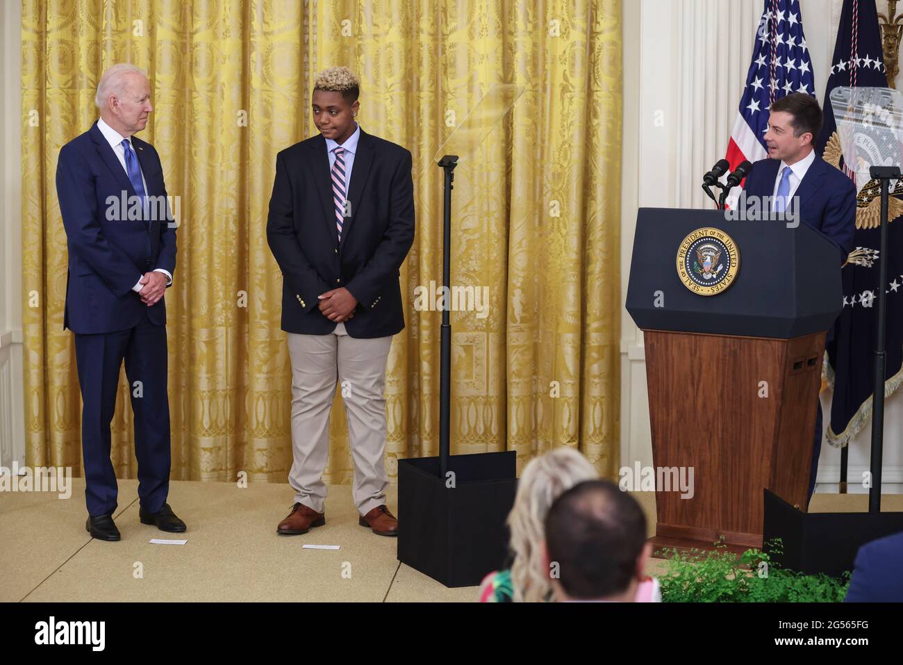 Transportation Secretary Pete Buttigieg, right, speaks as President Joe ...