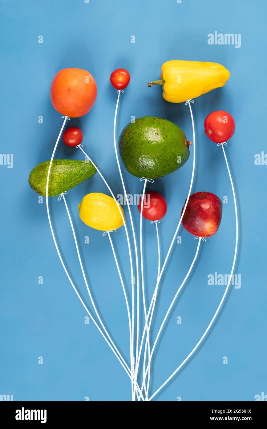 creative concept of mix of bunch of fruit fly in the air like balloon ...
