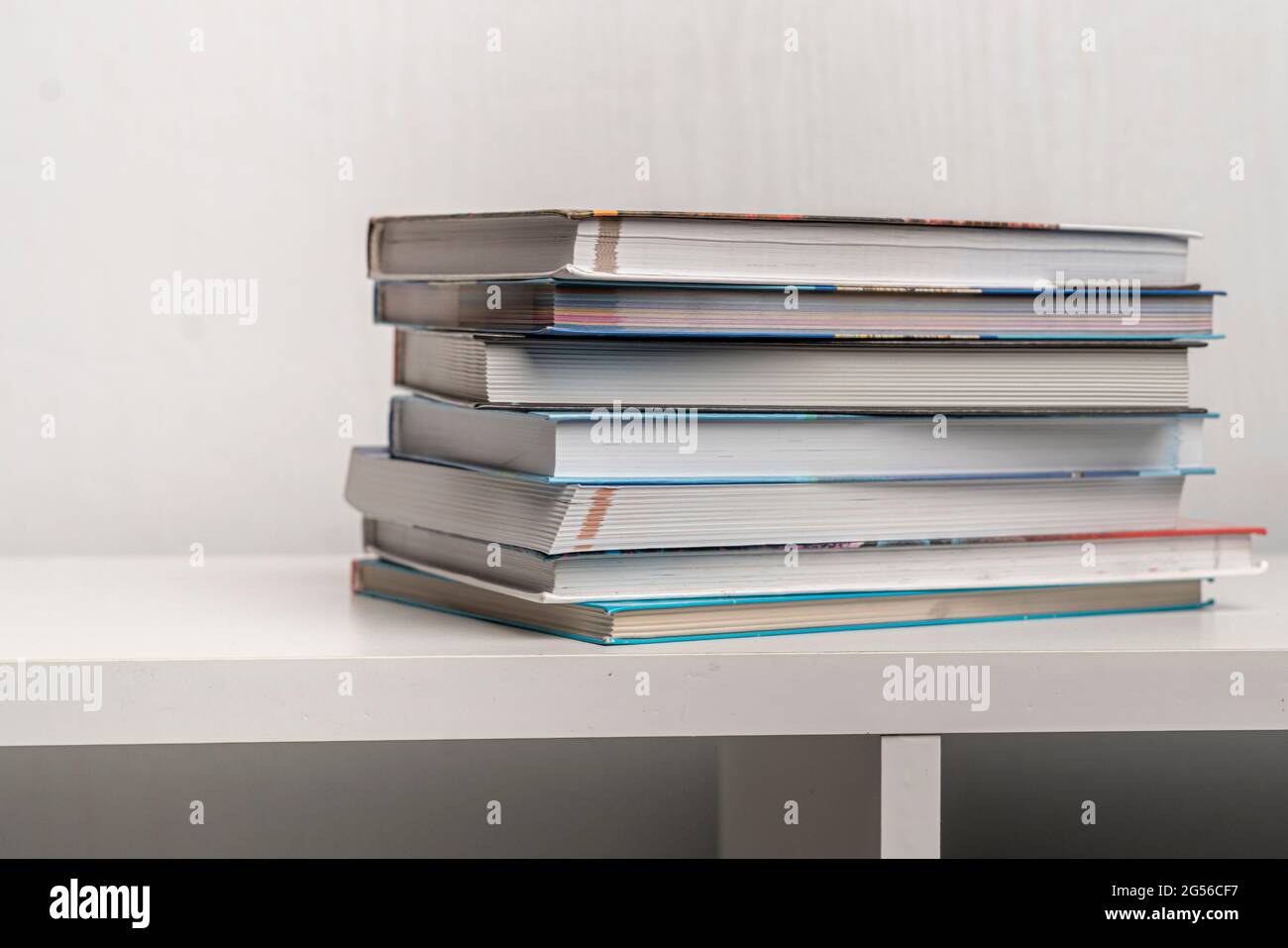a simple stack of books on the shelf at home Stock Photo - Alamy