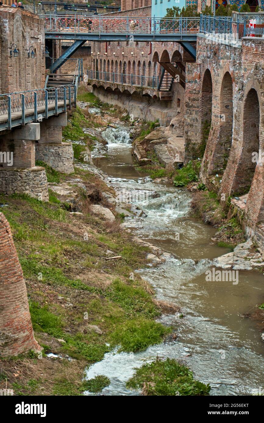 An old river channel with a small mountain river Stock Photo - Alamy