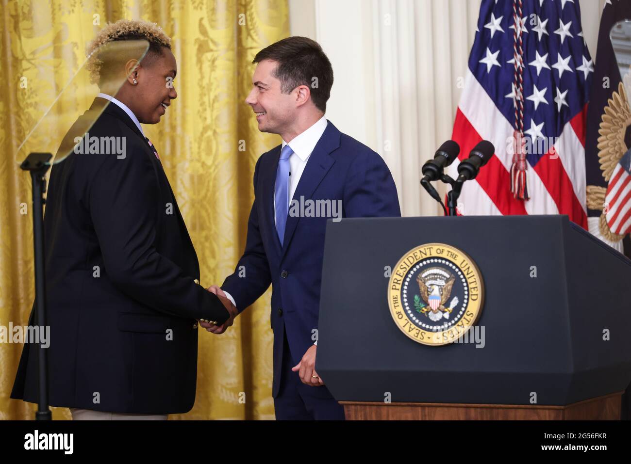 Transportation Secretary Pete Buttigieg shales hands with 16-year-old ...