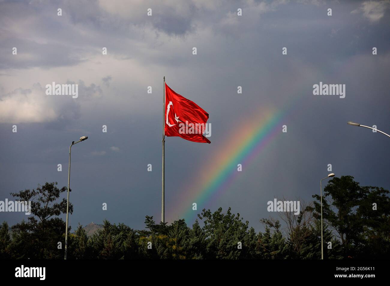 A view of a Turkish flag with a rainbow in the background after a ...