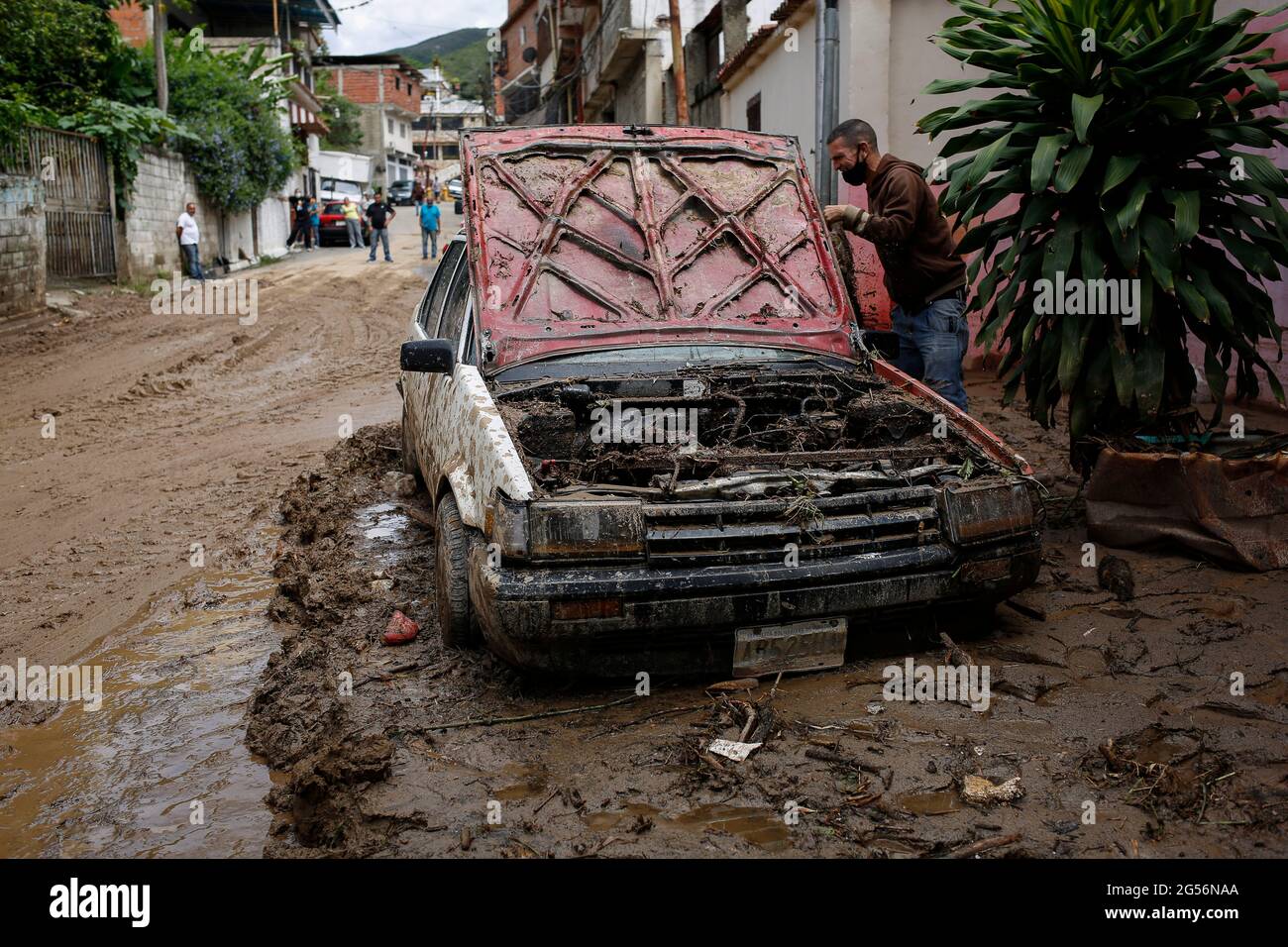 Caracas, Venezuela. 25th June, 2021. A man inspects his car, which is ...