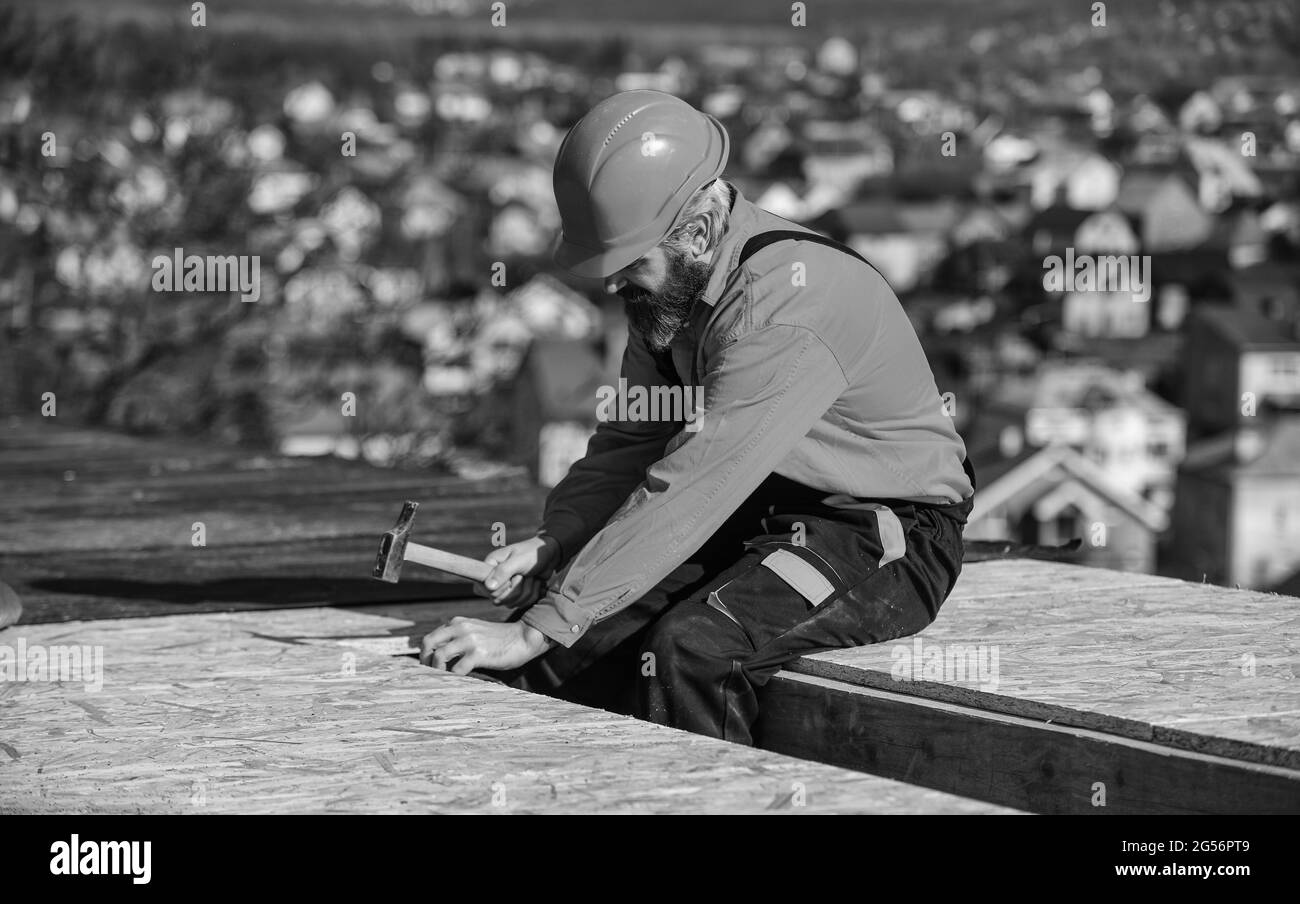 Construction Industry and Waterproofing. roofer working on roof ...