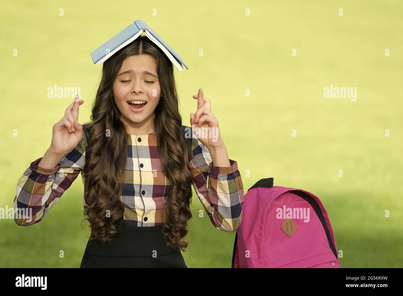 I dont want to jinx it. Superstitious child make wish holding book on ...