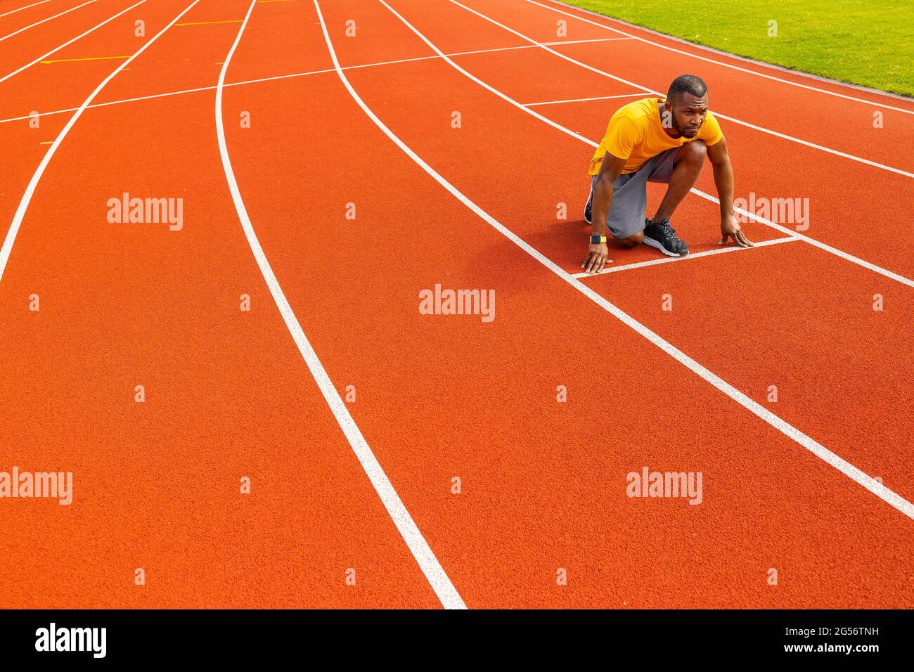 Fit focused afro-american male sportsman training hard and standing on ...