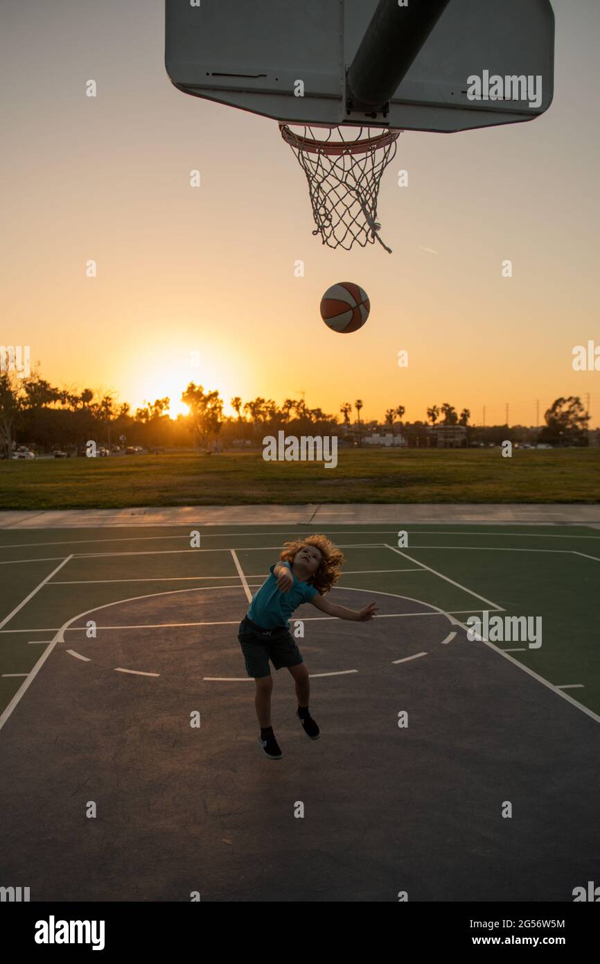 Happy little boy kid playing basketball on playground. Cute little boy ...