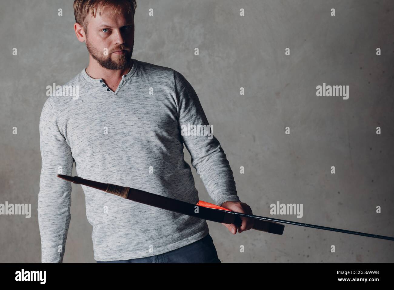 Archer bearded man with classic bow and arrow Stock Photo - Alamy