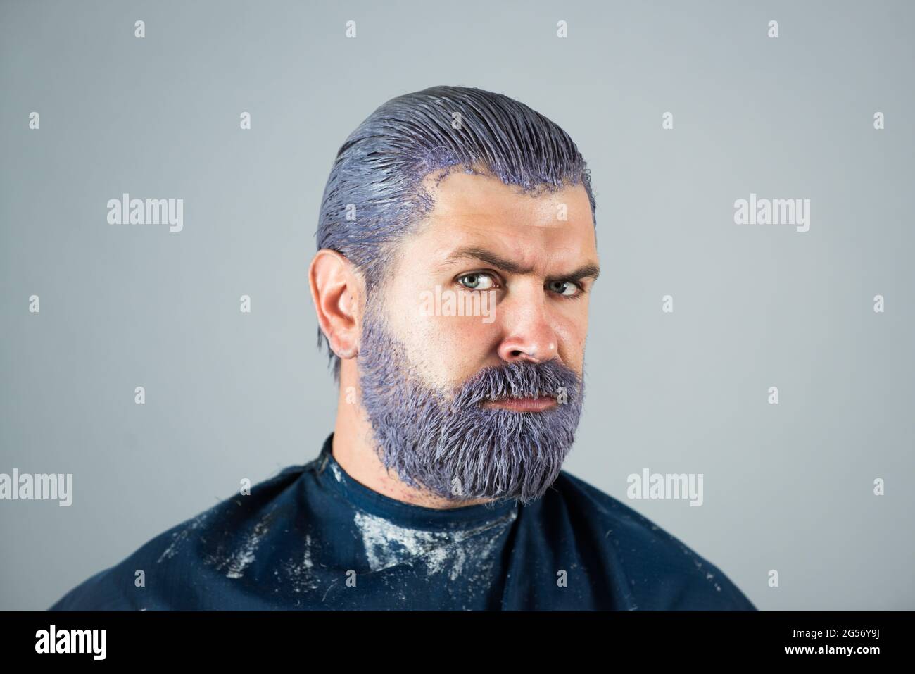 Man hair coloring. Bearded hipster guy. Process of a man having his ...