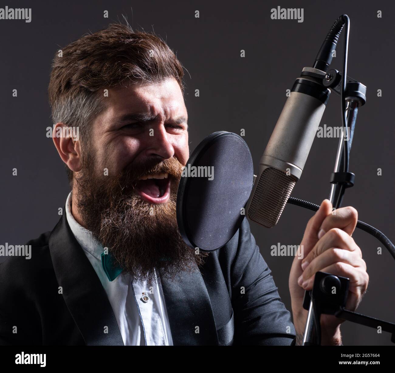 Classic singer is performing a song with a microphone while recording ...