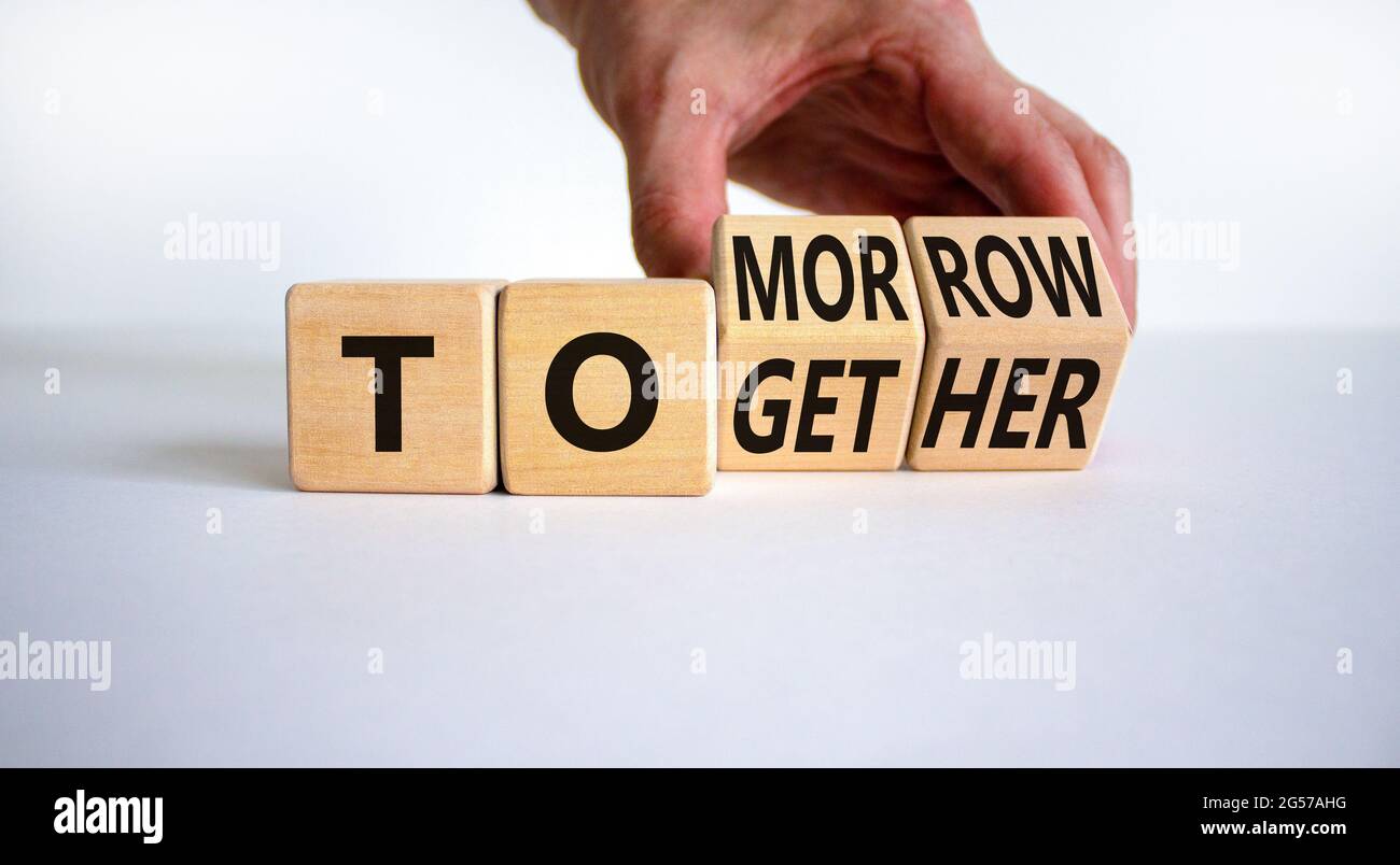 Tomorrow we will together symbol. Businessman turns wooden cubes and ...