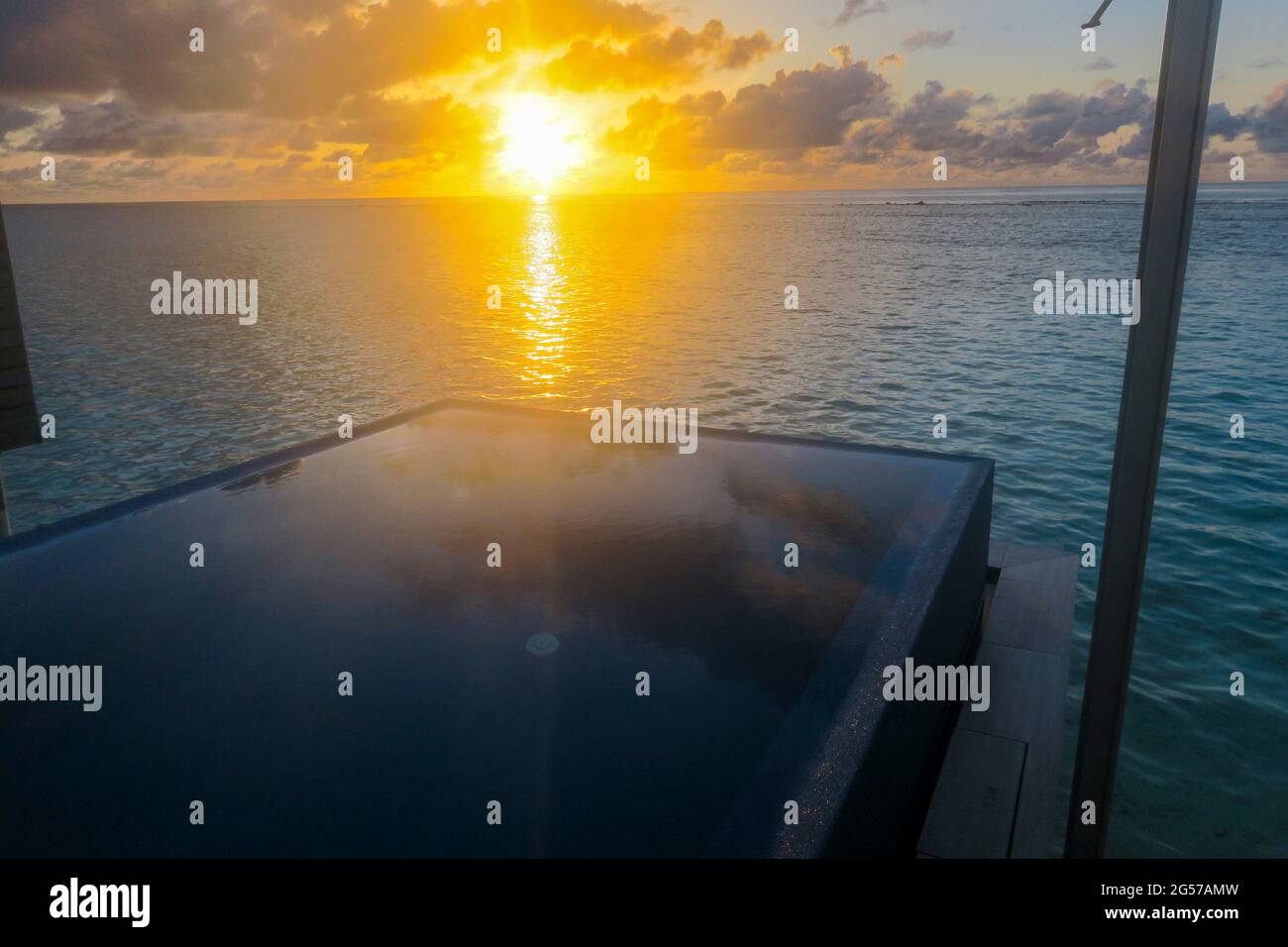 Sunset view from Infinity Pool, South Ari Atoll, Maldives Stock Photo ...