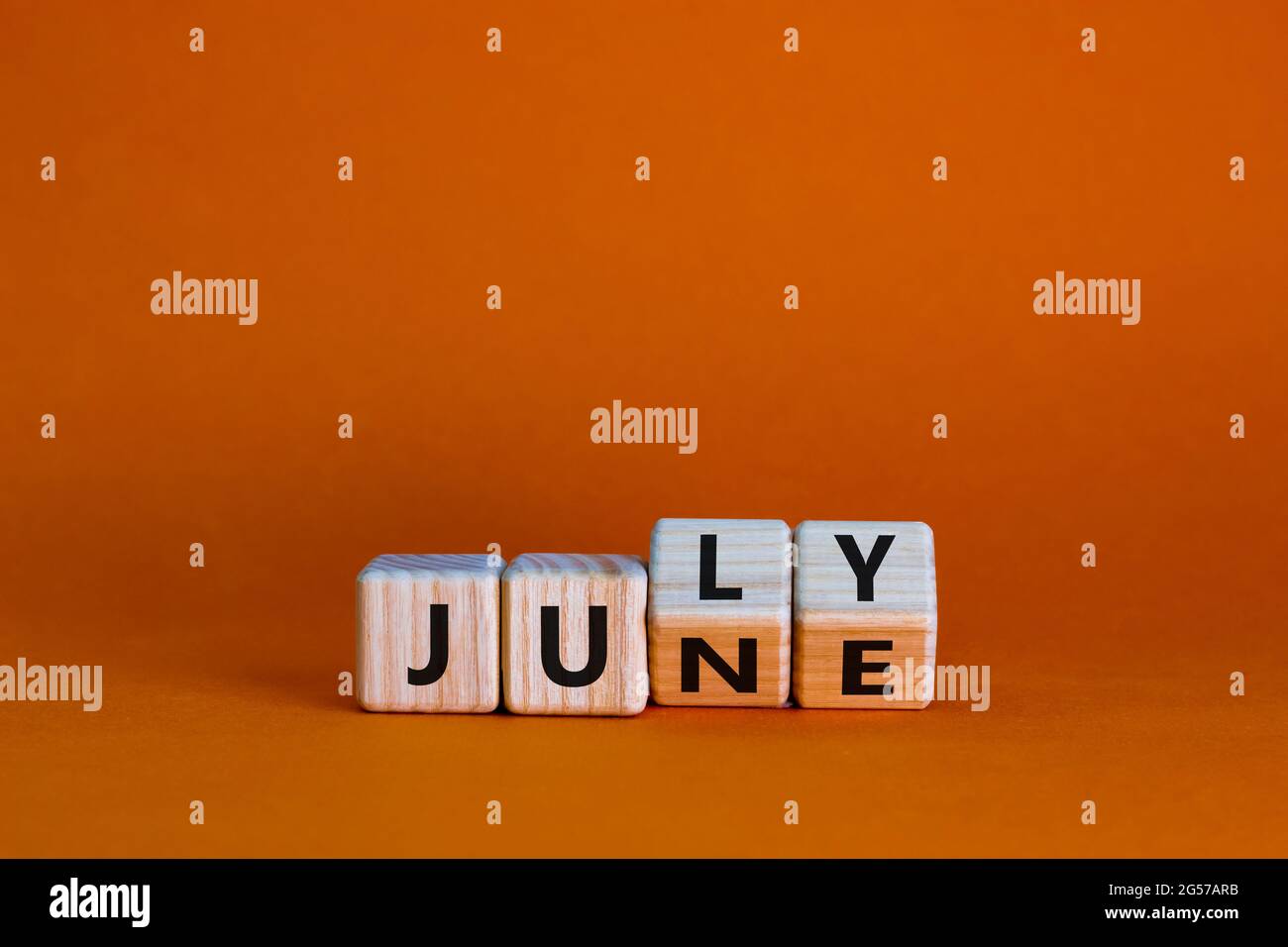 From june to july symbol. Turned wooden cubes and changed the word ...