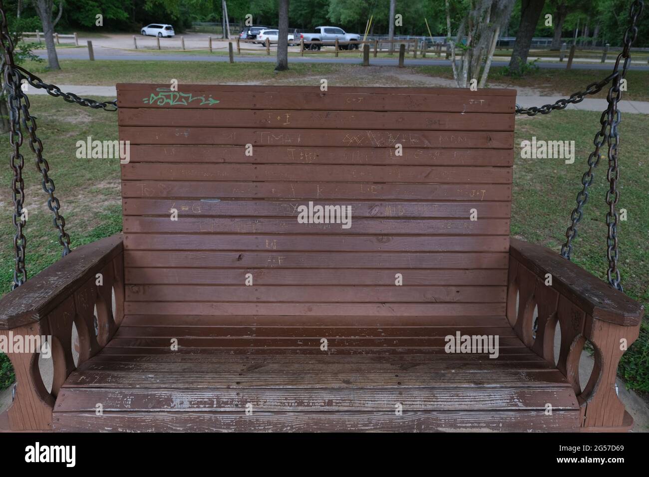 Chain link aged park swing bench with names etched in Tom Brown Park in ...