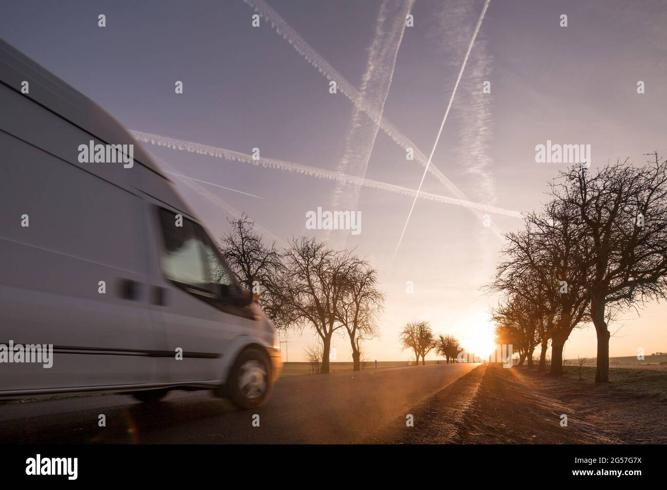 Sunrise on the road with car going forward sun Stock Photo - Alamy