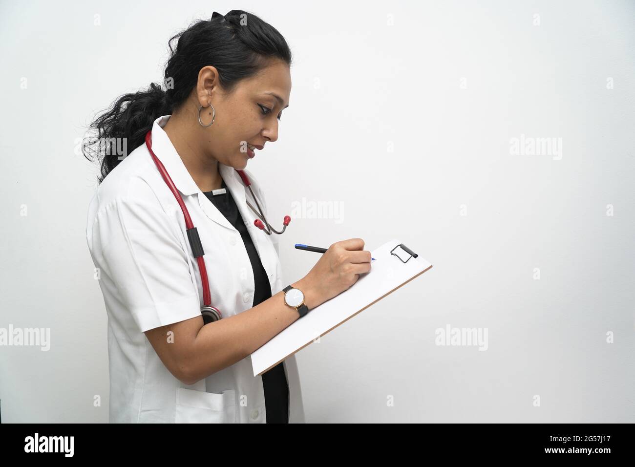 Indian female doctor writing prescription hi-res stock photography and ...