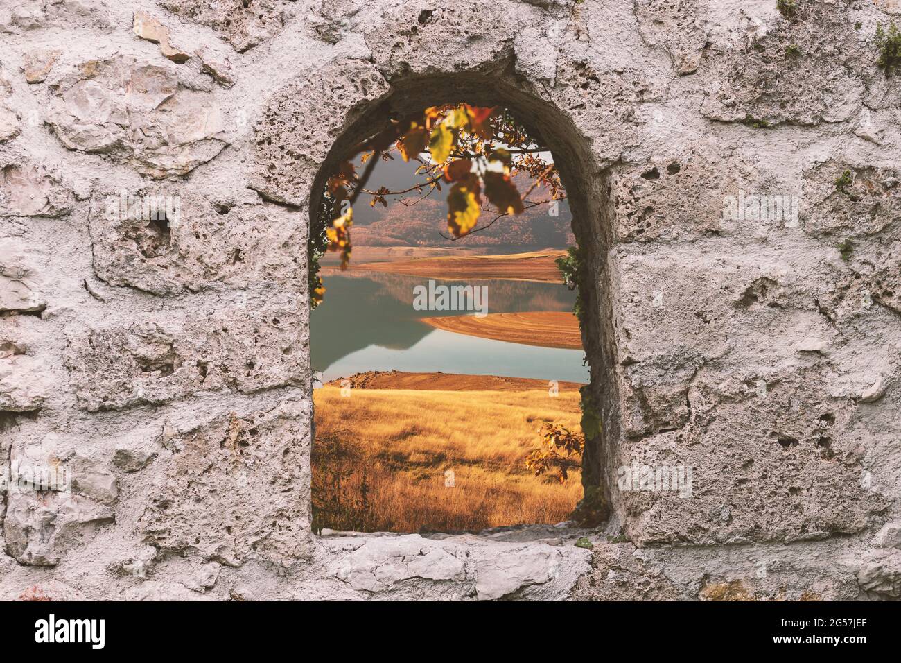 Scenic view of a tranquil lake seenthrough a stone arch window Stock ...