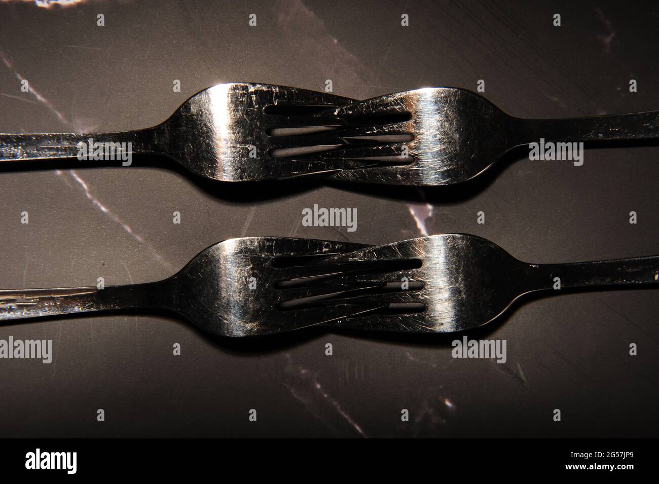 Overhead shot of four scratched, worn-out forks coupled together Stock ...