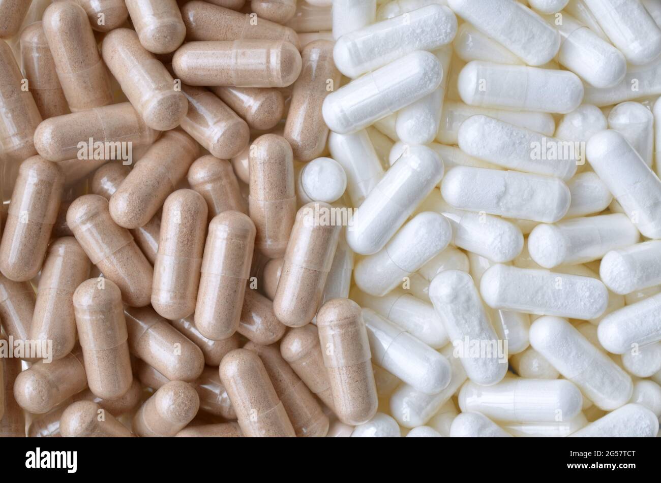 Vitamins and supplements. Lots of white and beige capsules as a ...