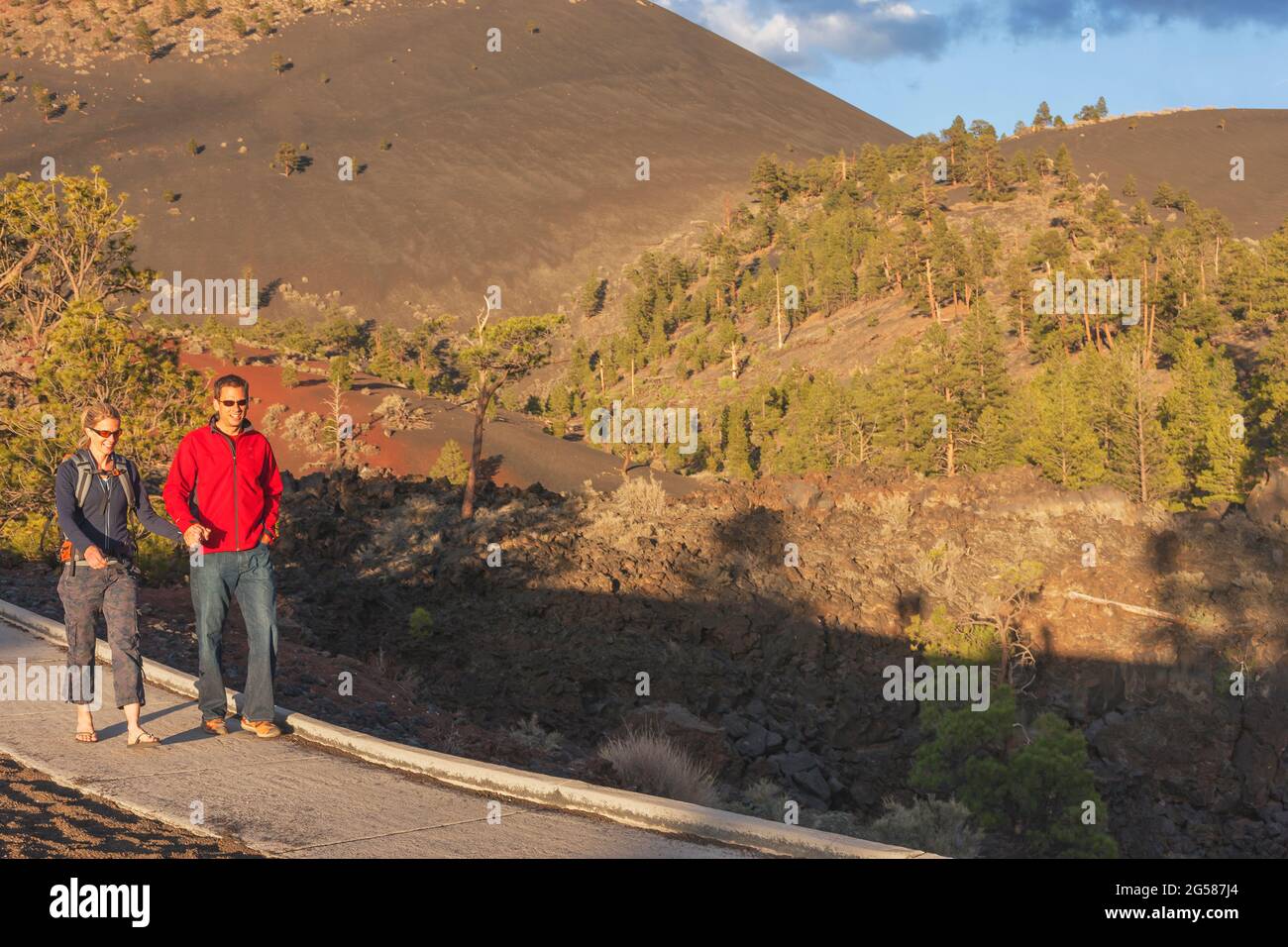 Couple walking on pathway, Sunset Crater Volcano National Monument ...