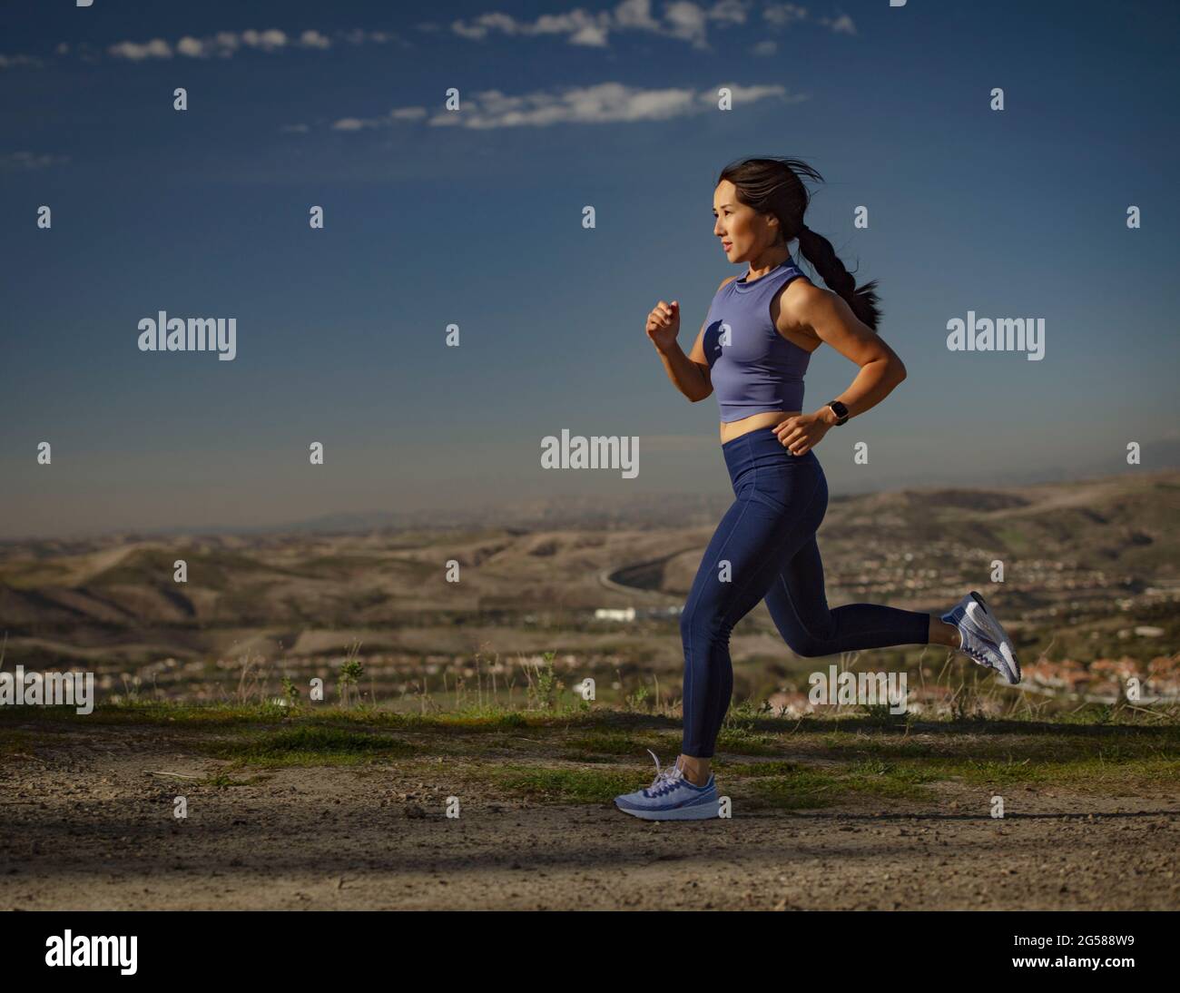 Woman jogging in landscape Stock Photo - Alamy