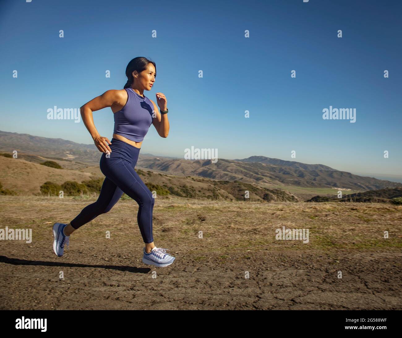 Woman jogging in landscape Stock Photo - Alamy