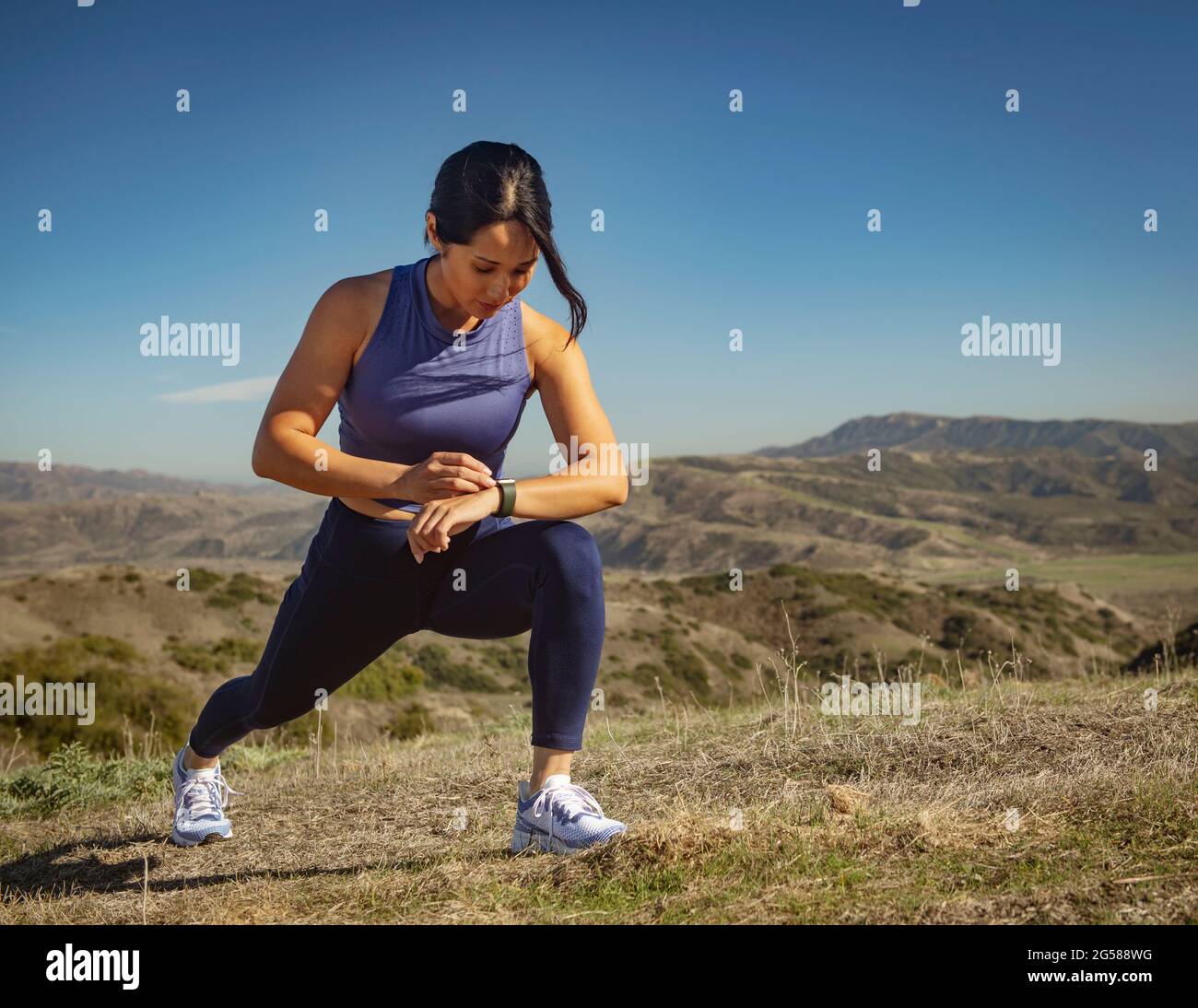 Woman stretching in landscape Stock Photo - Alamy