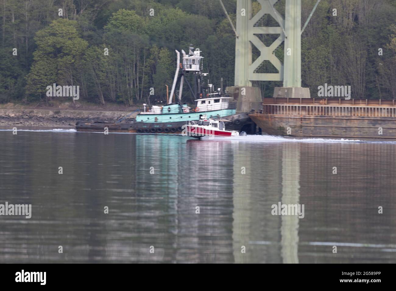 two boats under a bridge over calm water Stock Photo - Alamy