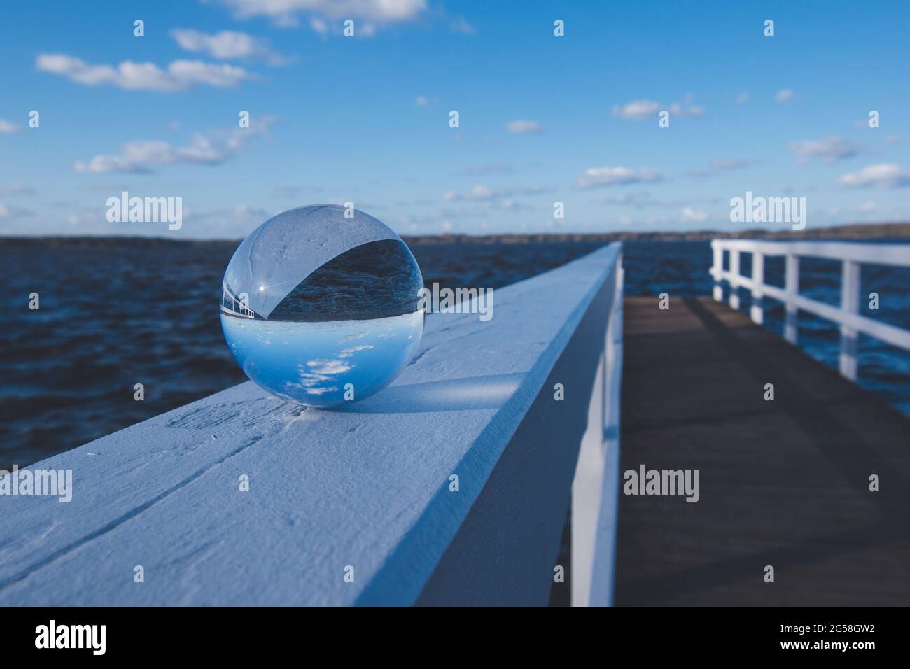 Reflective crystal ball on a dock by the sea Stock Photo - Alamy