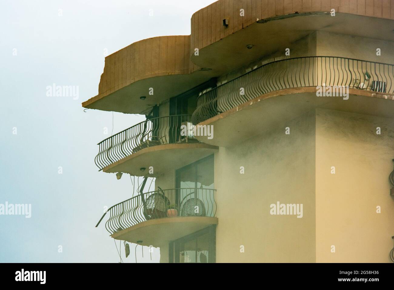 Surfside, Florida, USA. 25th June, 2021. USA: Smoke coveres the remains of the collapsed condo ...