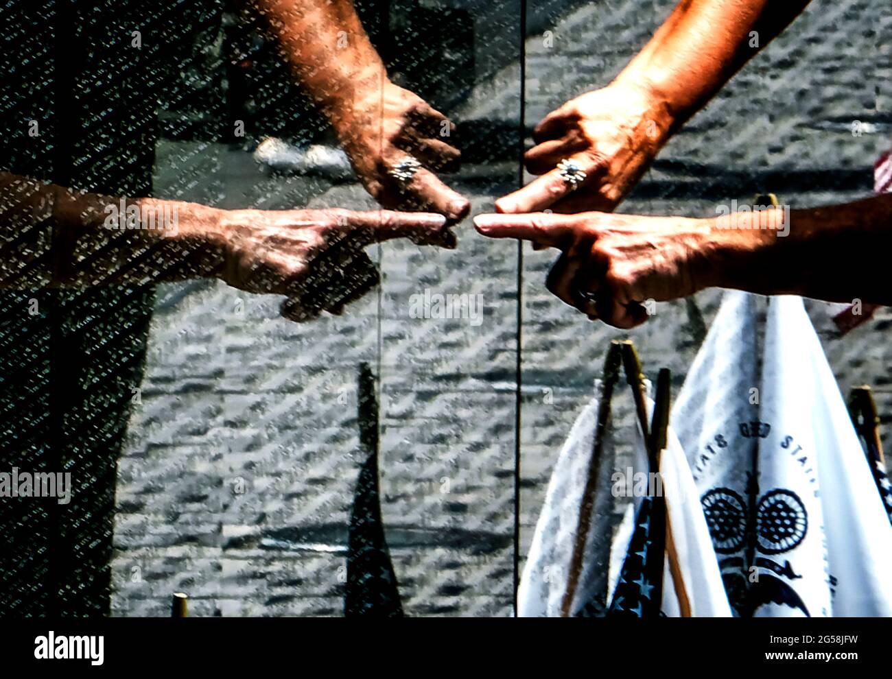 Pointing fingers find a name on the Vietnam War Memorial in Washington ...