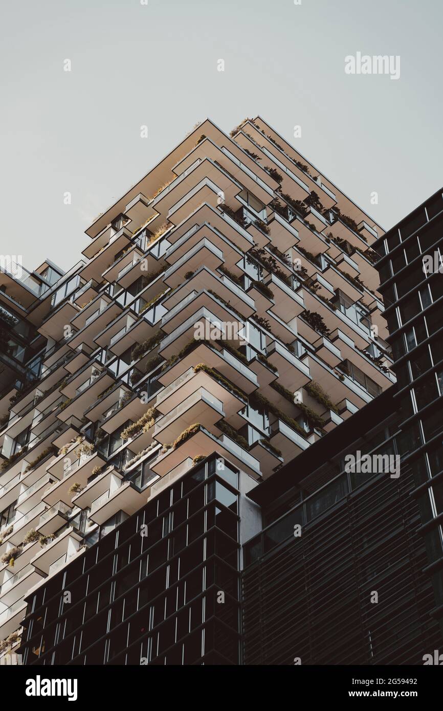 Geometric lines of a modern apartment building with exterior plants ...