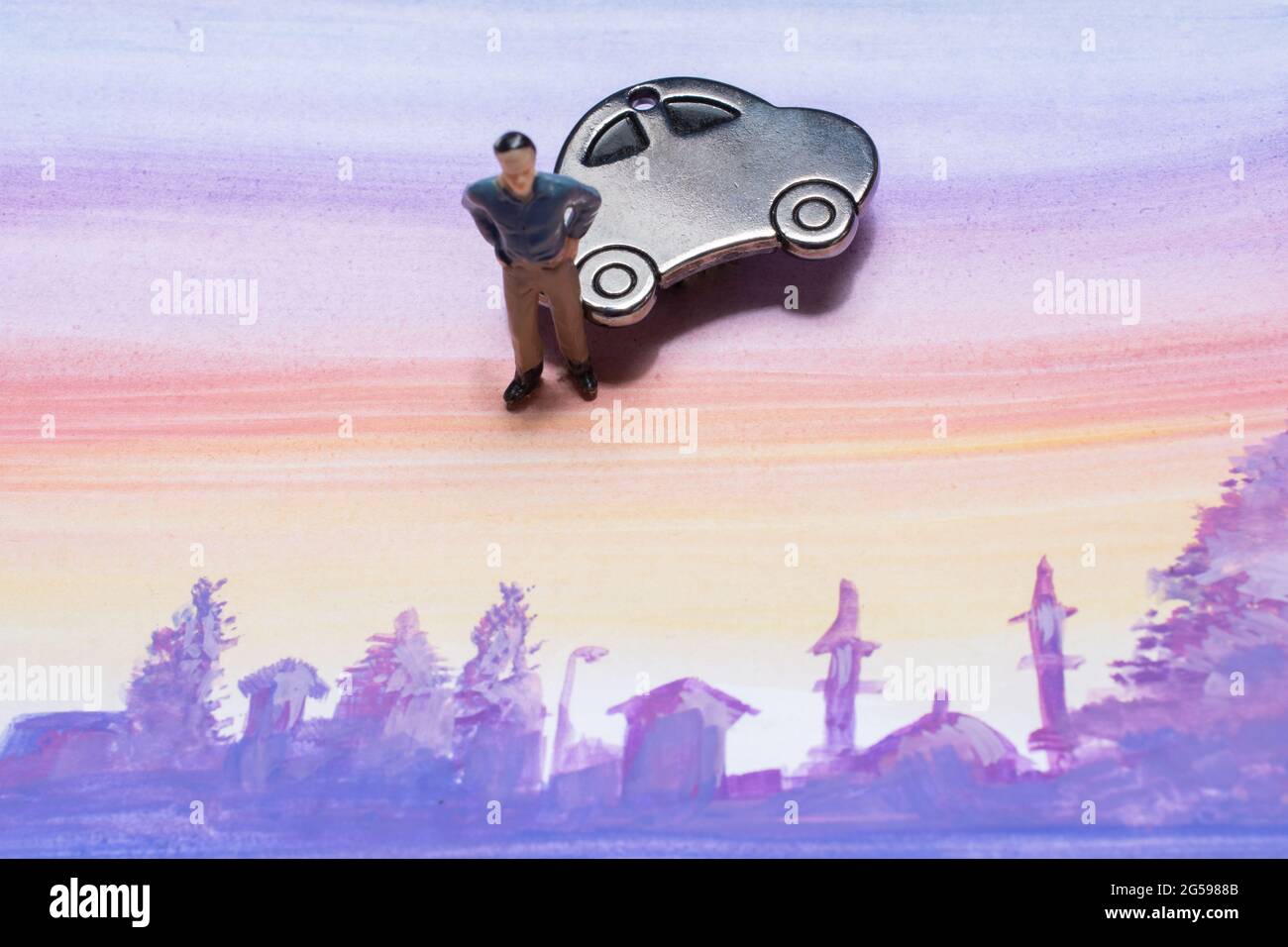 Closeup of a miniature man and a car on an abstract background Stock ...