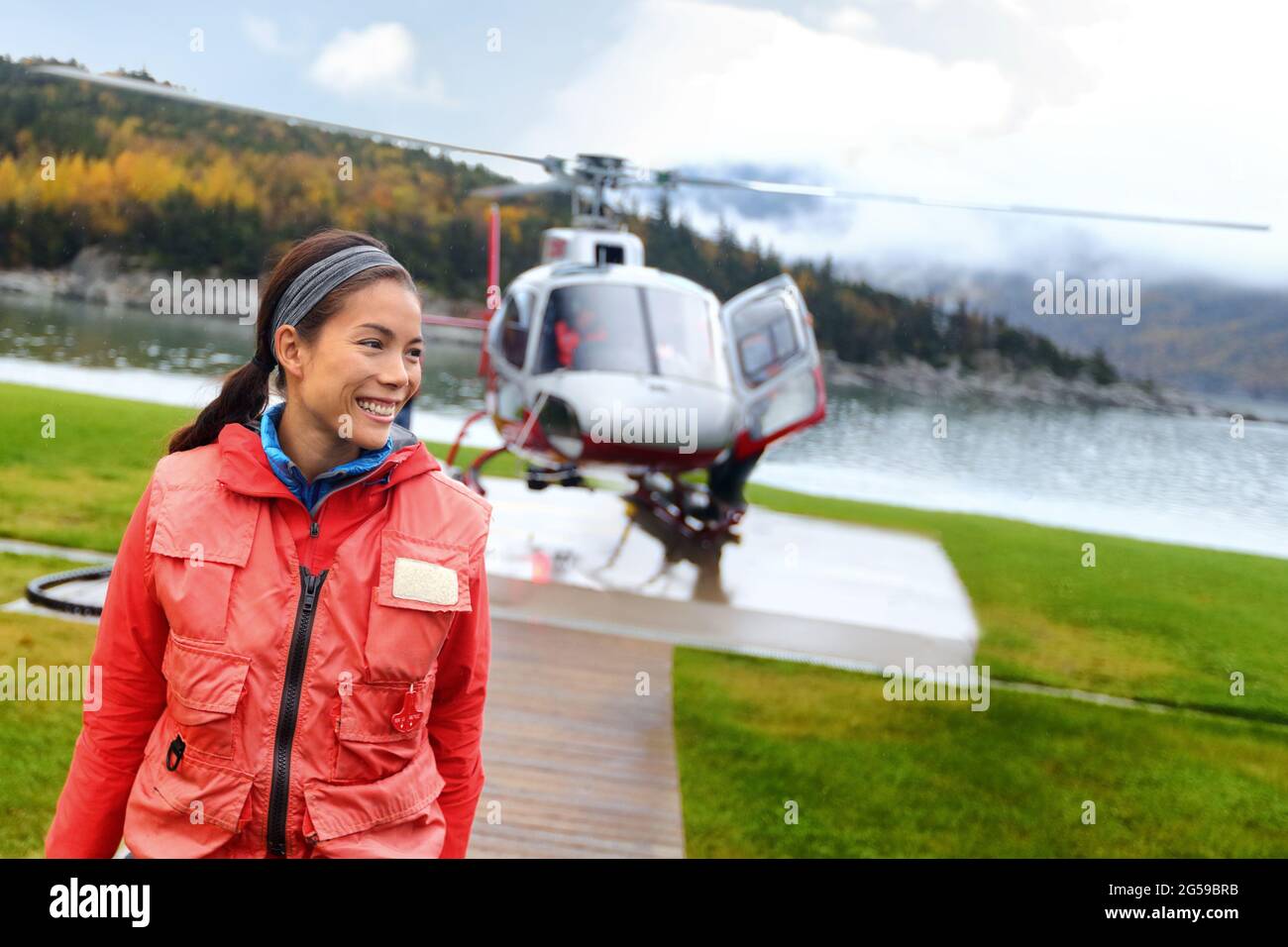 Helicopter woman tourist taking flight on tour excursion. Asian woman ...