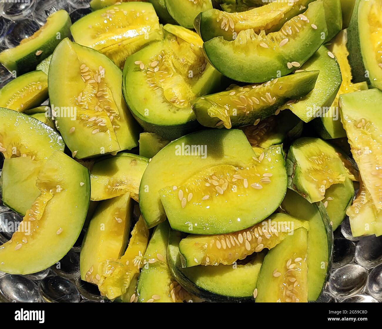 fresh yellow muskmelon slices on the glass plate in the buffet Stock ...