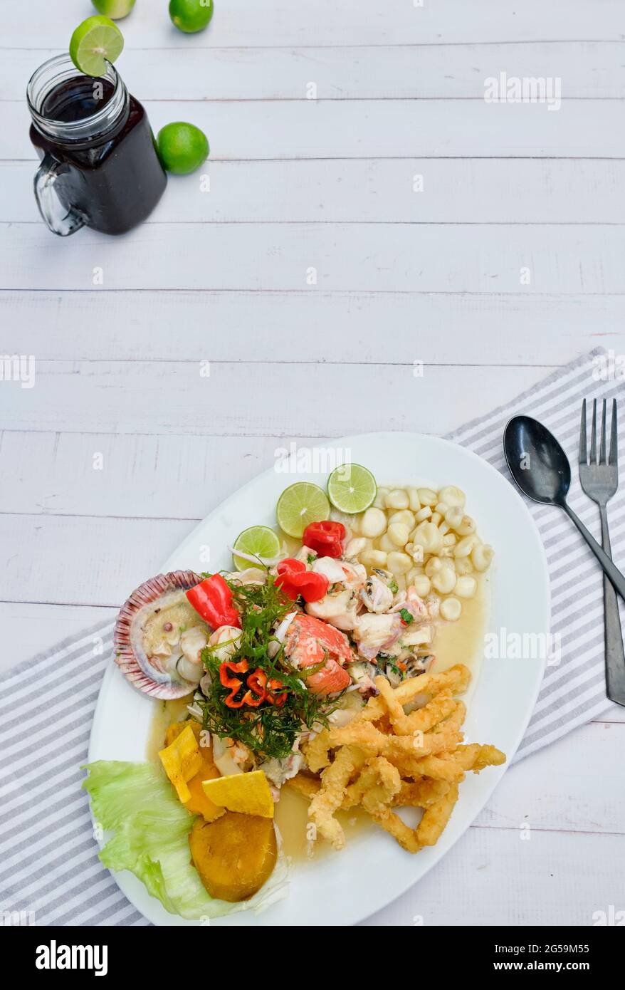 Typical Peruvian food, squid ceviche, shrimp, crab and white fish with ...