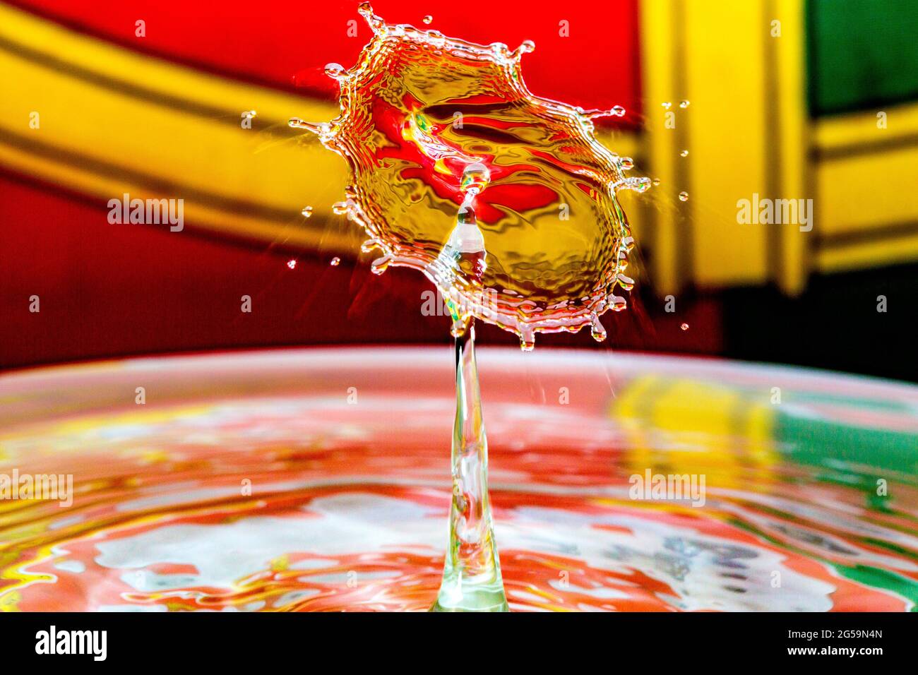 Colour splash of a water drop collision Stock Photo - Alamy