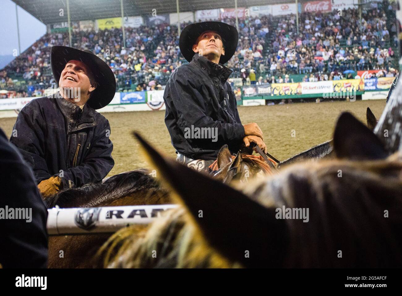 Reno, USA. 24th June, 2021. Pickup men laugh in the rain with the ...