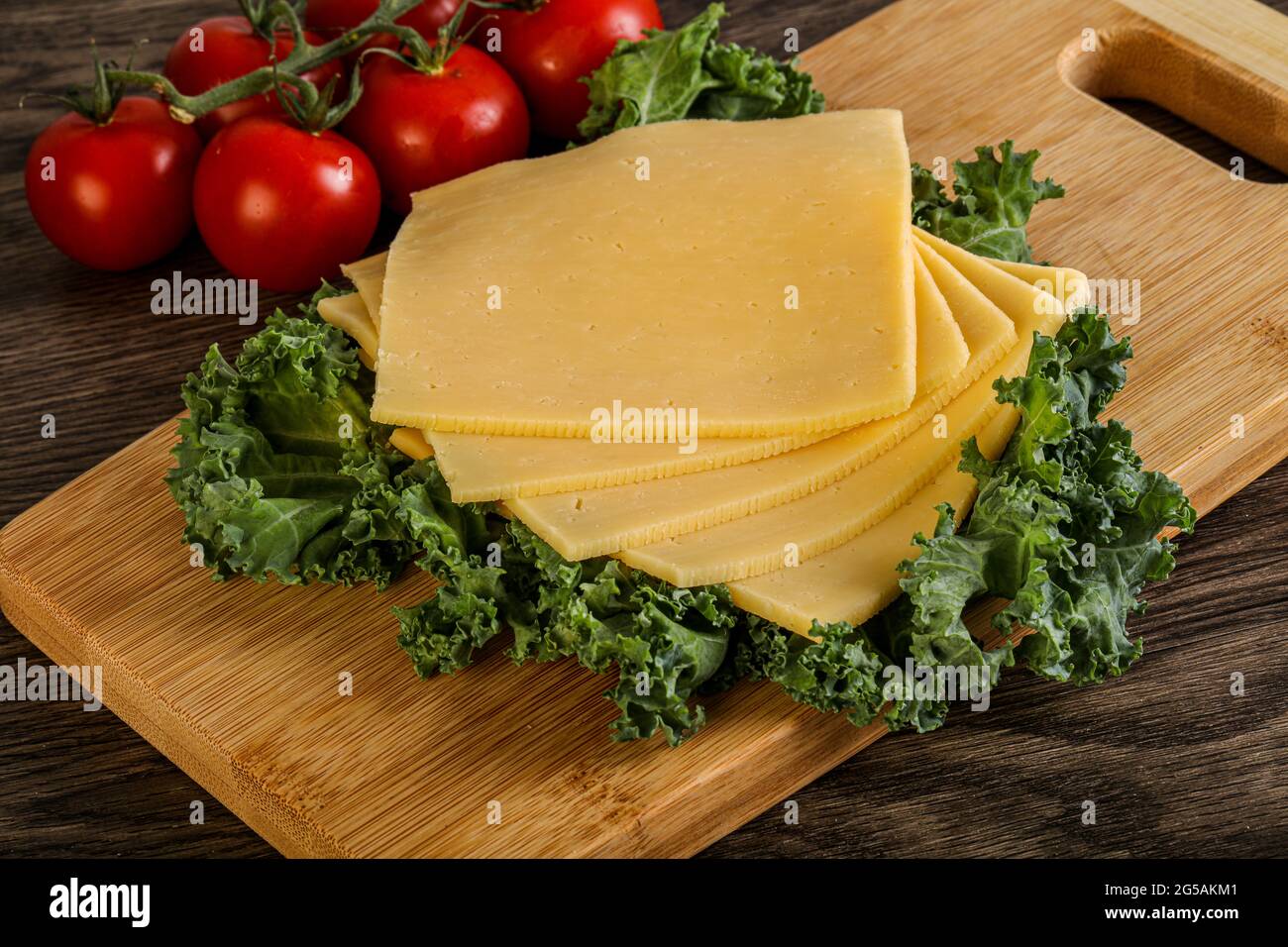 Sliced Gauda cheese snack over board Stock Photo - Alamy