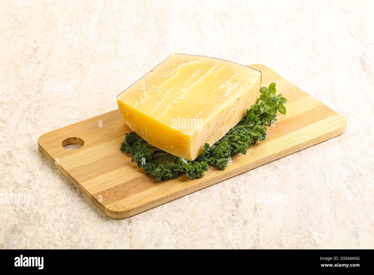 Hard Parmesan cheese piece over board Stock Photo - Alamy