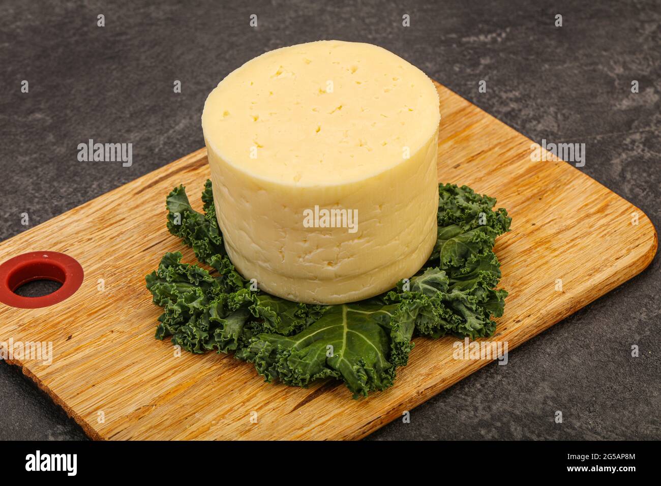 Yellow round dairy soft cheese piece Stock Photo - Alamy