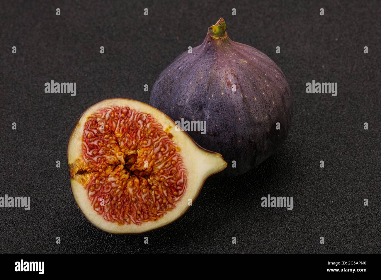 Sweet purple slice of fig fruit Stock Photo - Alamy