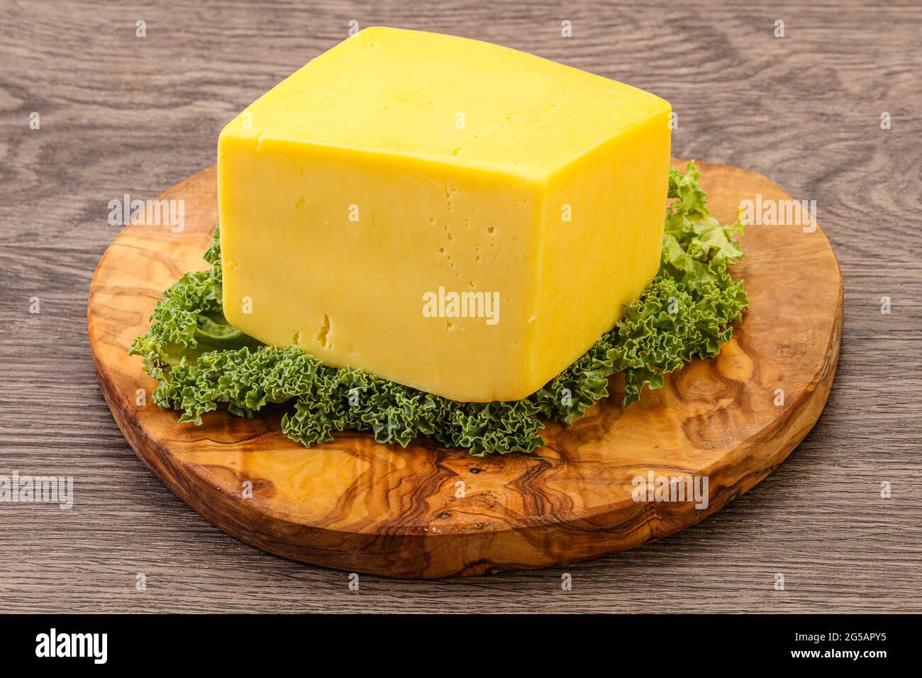 Yellow tilsiter cheese dairy product brick Stock Photo - Alamy