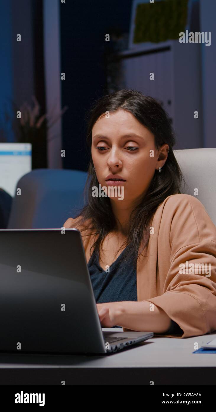 Workaholic entrepreneur woman sitting at desk table analysing financial ... Workaholic entrepreneur woman sitting at desk table analysing financial ...