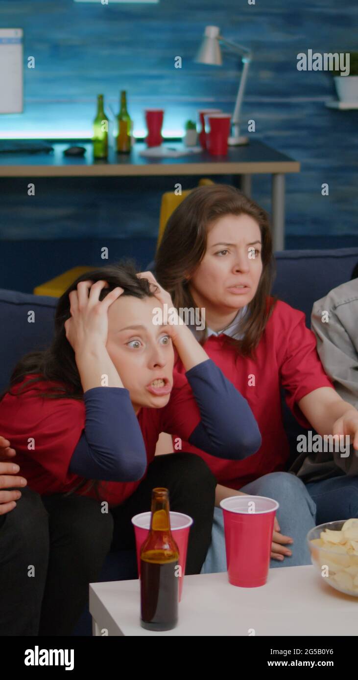 Group of multiethnic people frustrated after football team losing match ...