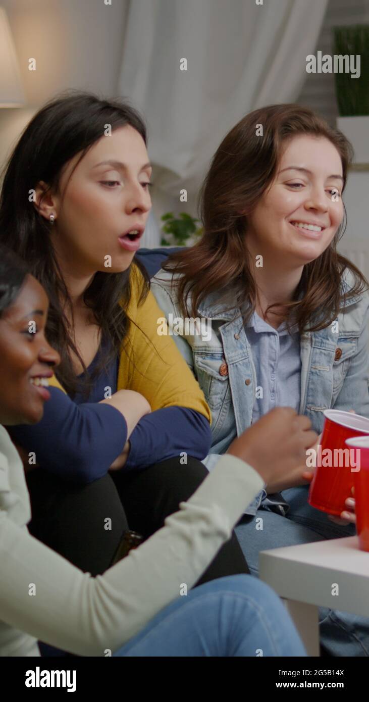 Multiethnic friends sitting on couch having online videocall meeting ...