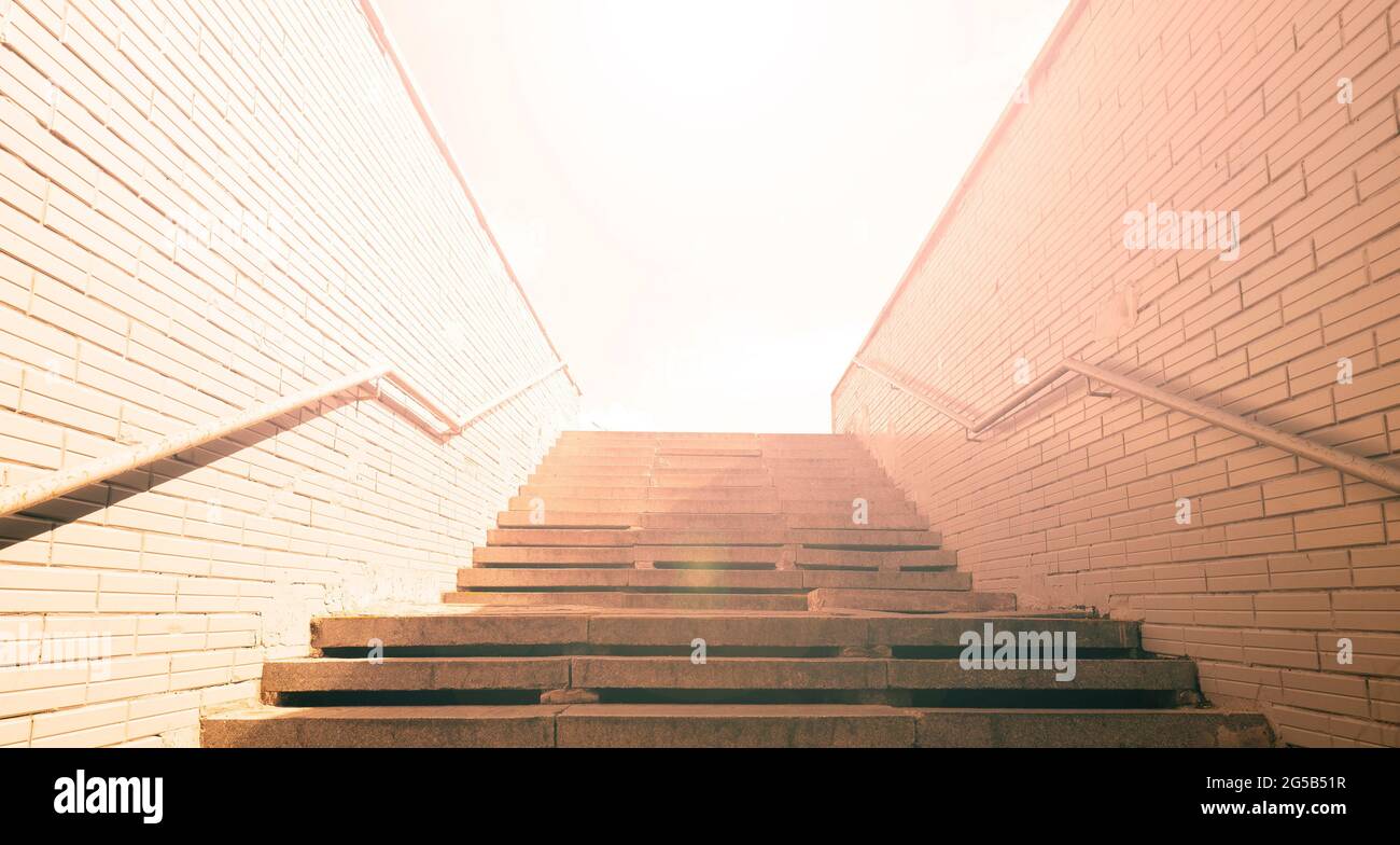 Bottom view of the steps up from the underpass in the city, under the ...