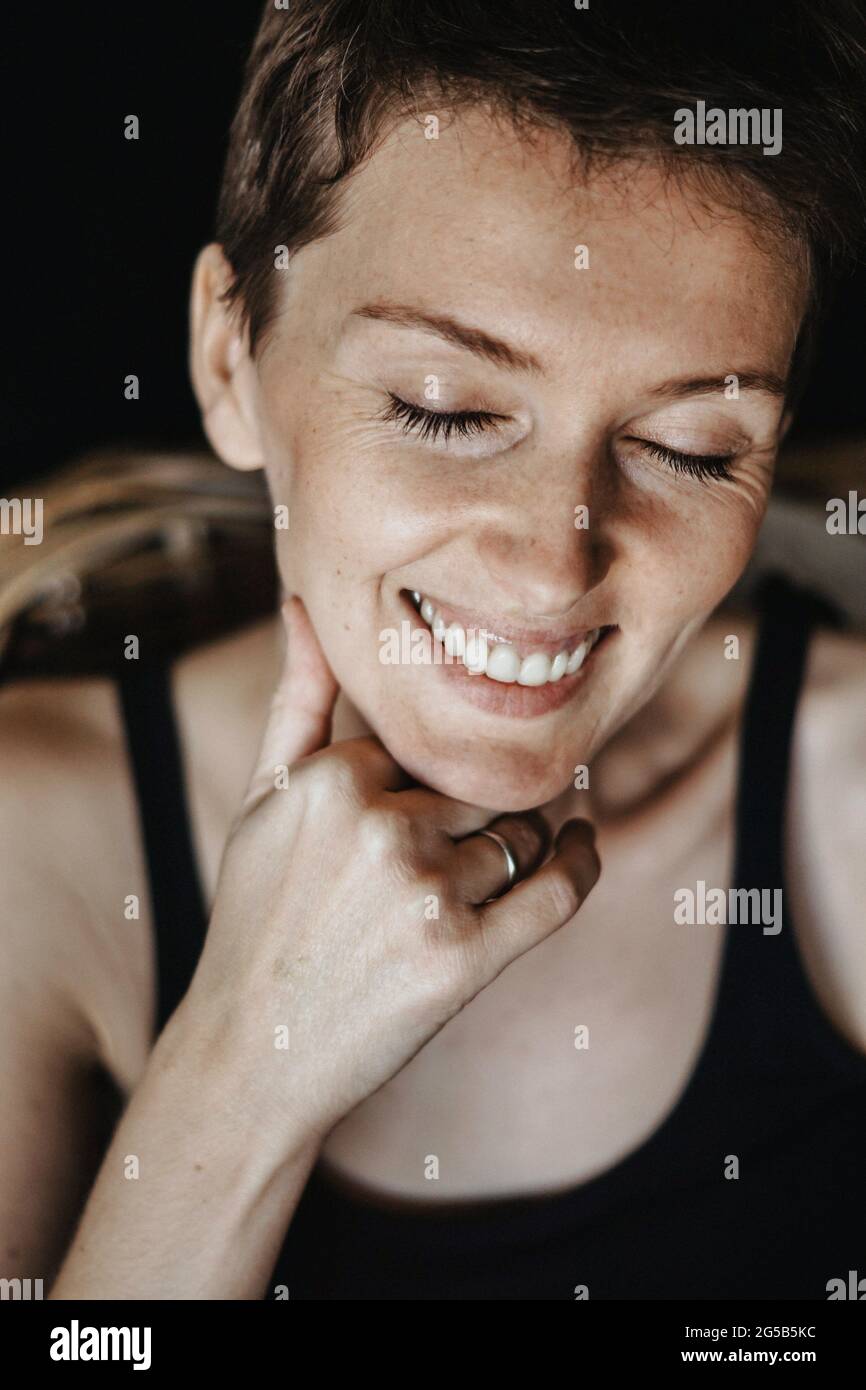 High angle shot of a beautiful smiling middle-aged female with a hand ...