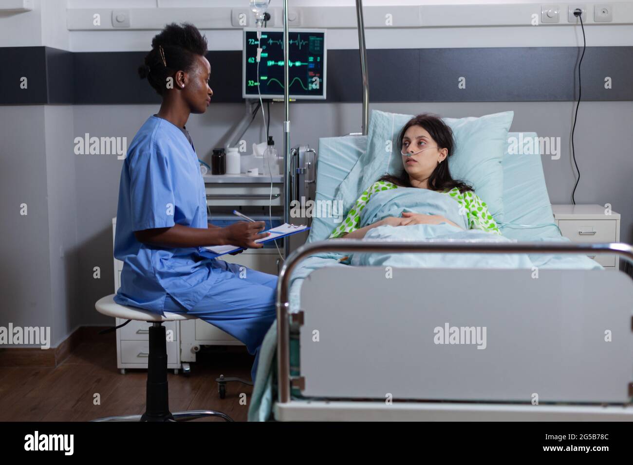 Black woman nurse in uniform writing sickness diagnosis on clipboard ...