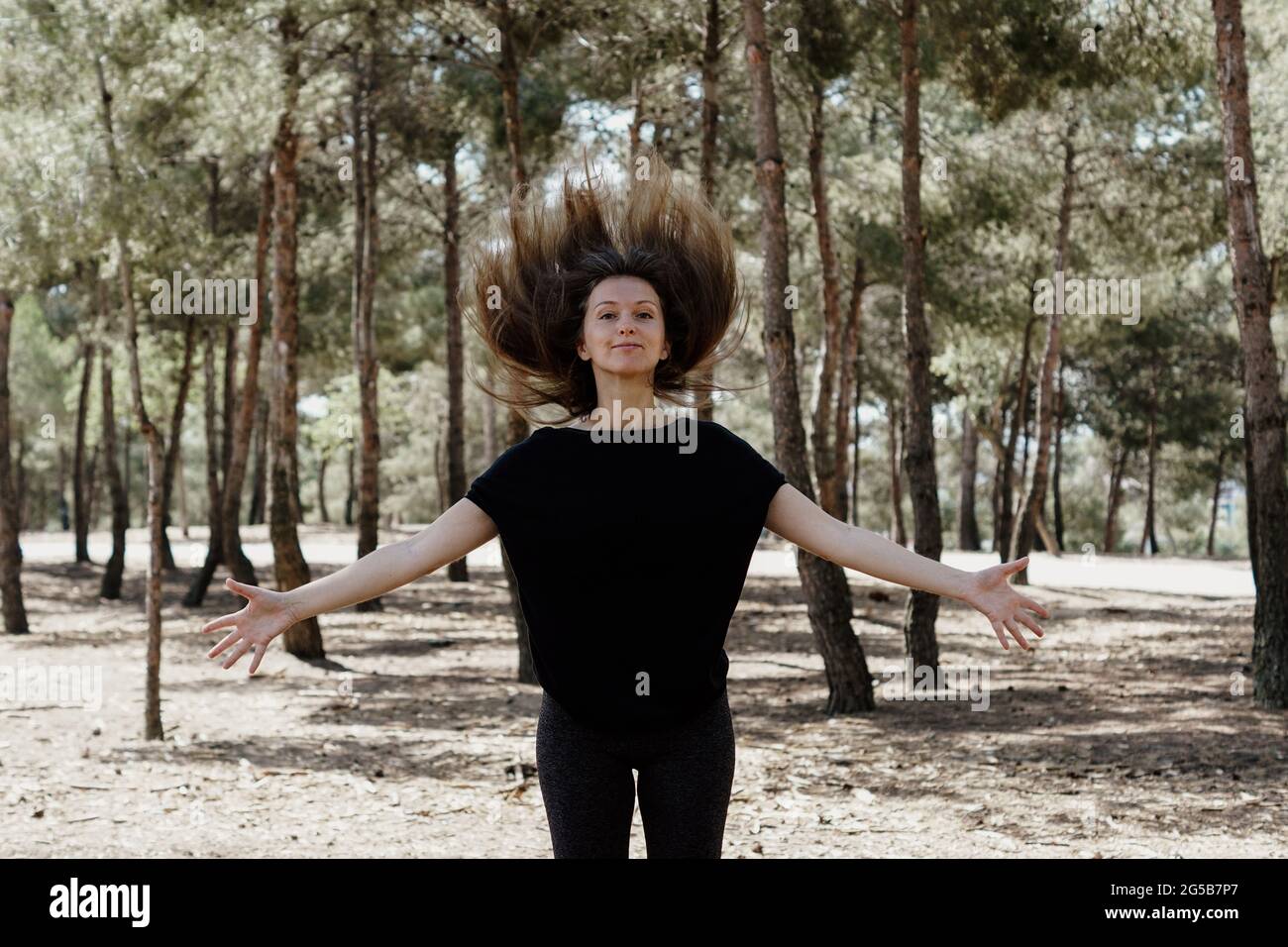 Closeup shot of a middle-aged female in sportswear whipping her hair ...